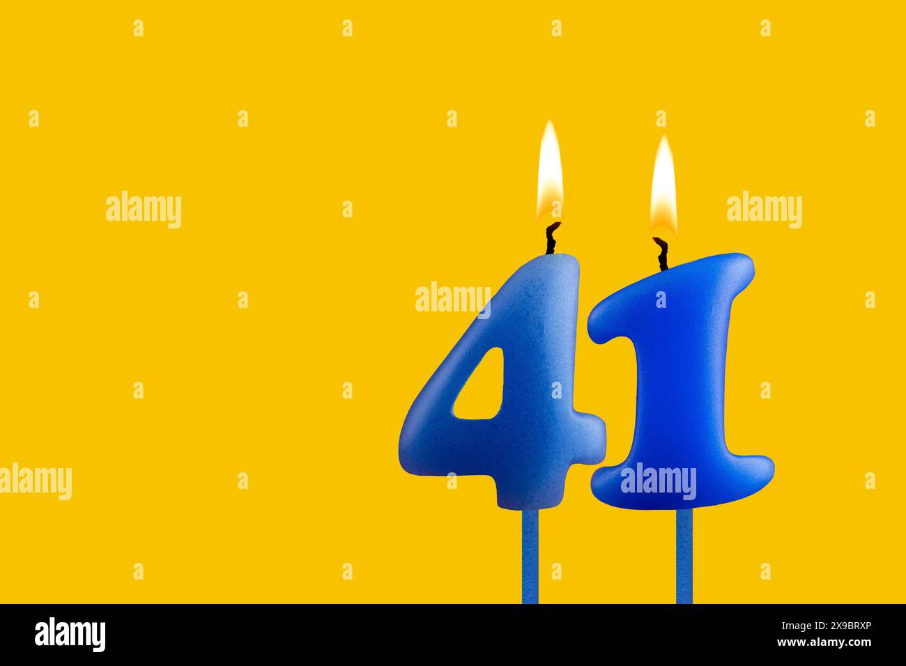 Blue birthday candle on yellow background - Number 41 Stock Photo - Alamy