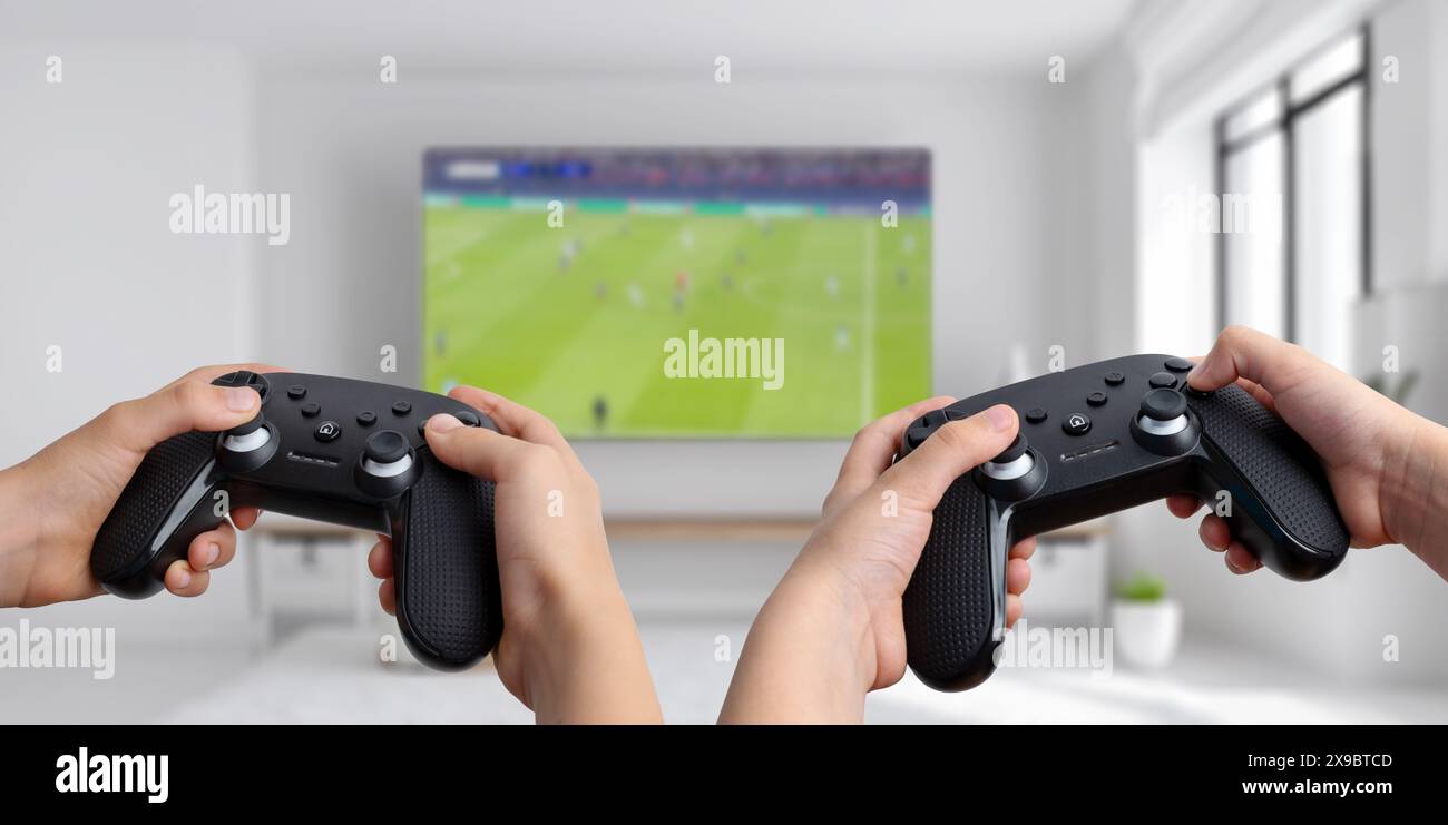 Soccer gaming fun on a big screen as two players use gamepads. Great ...