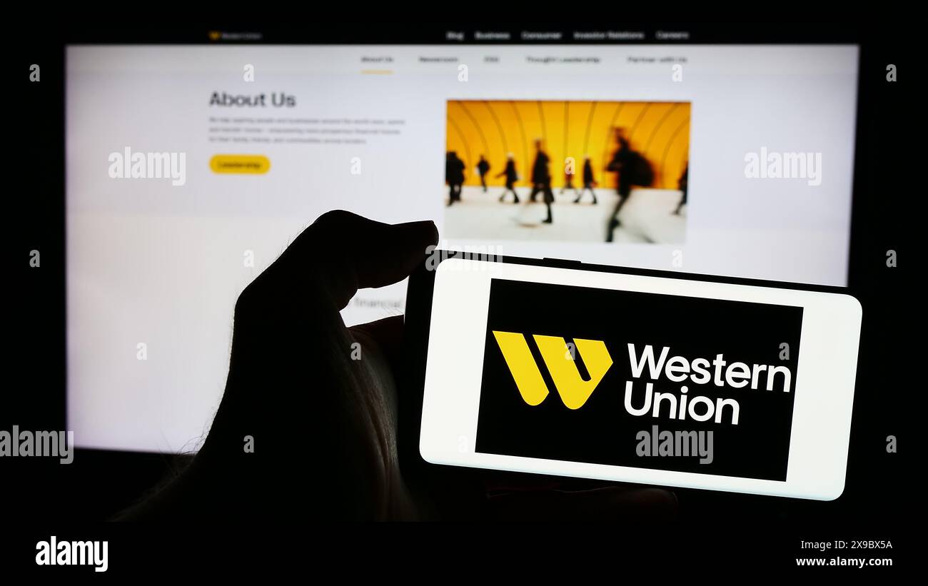 Person holding smartphone with logo of US financial services business ...