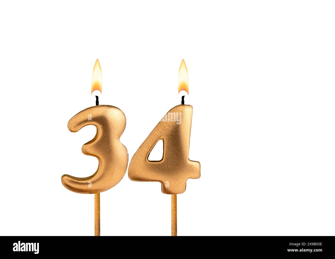 Birthday number 34 - Golden candle on white background Stock Photo - Alamy
