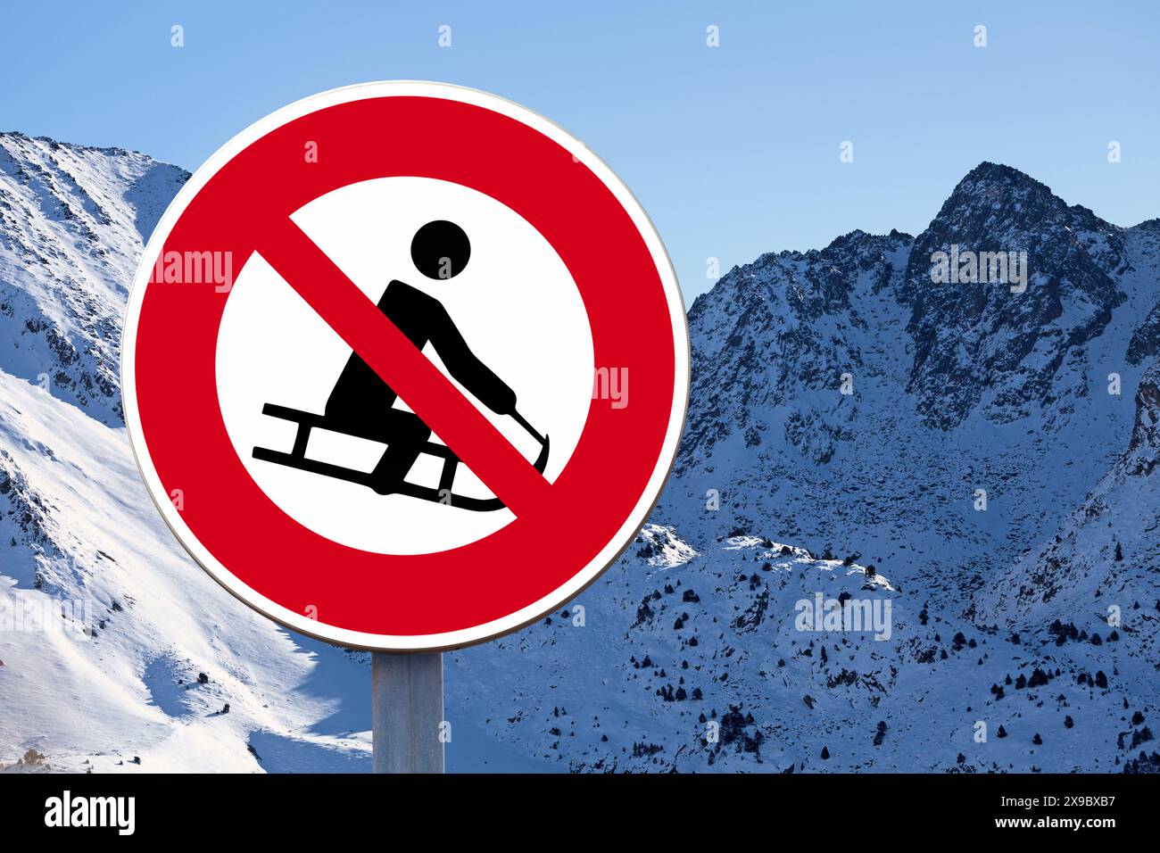 Round forbidden sign with with a man on a sled symbol drawn in the ...