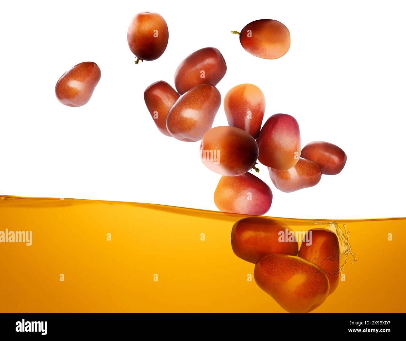 Palm fruits falling into cooking oil on white background Stock Photo ...