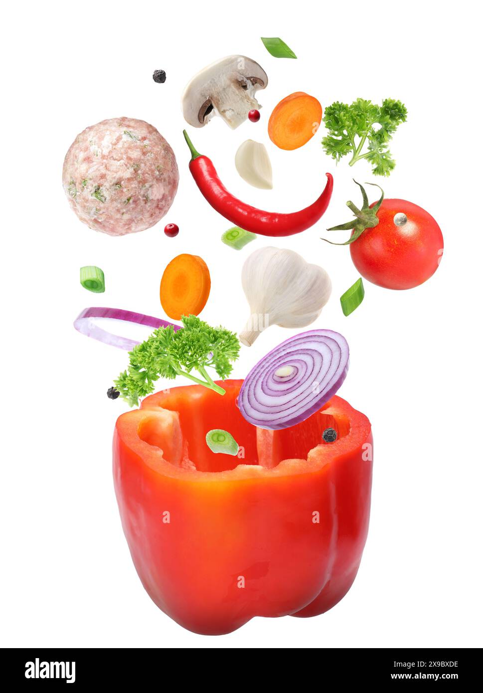 Stuffed pepper recipe. Fresh ingredients falling into bell pepper on ...