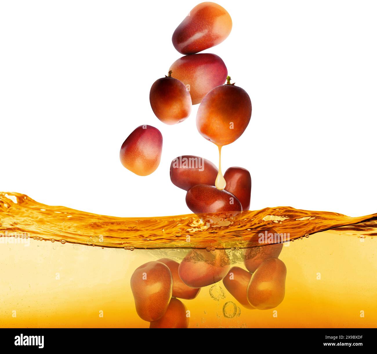 Palm fruits falling into cooking oil on white background Stock Photo ...
