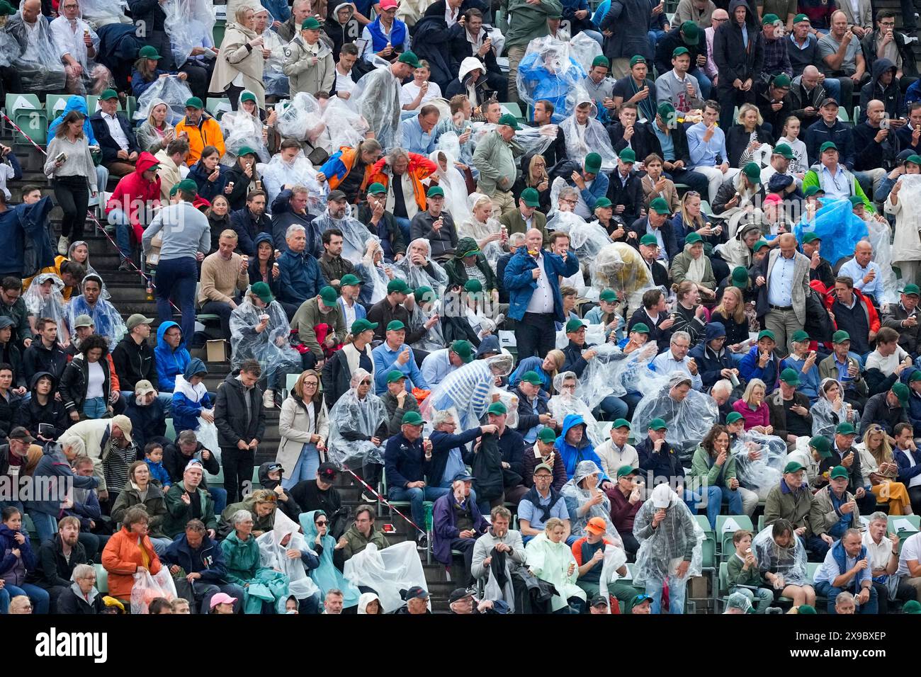 Oslo 20240530. The audience at Bislett Stadium have donned rain ponchos ...
