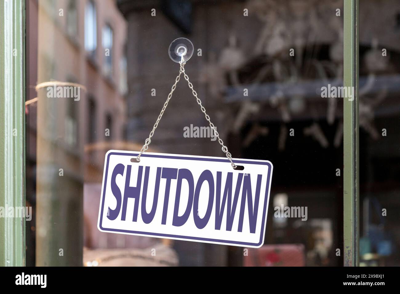 Close-up on a purple and white sign in a window with written in it ...