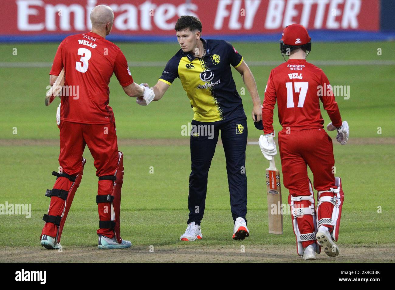 Matty Potts of Durham congratulates Luke Wells of Lancashire Lightning ...