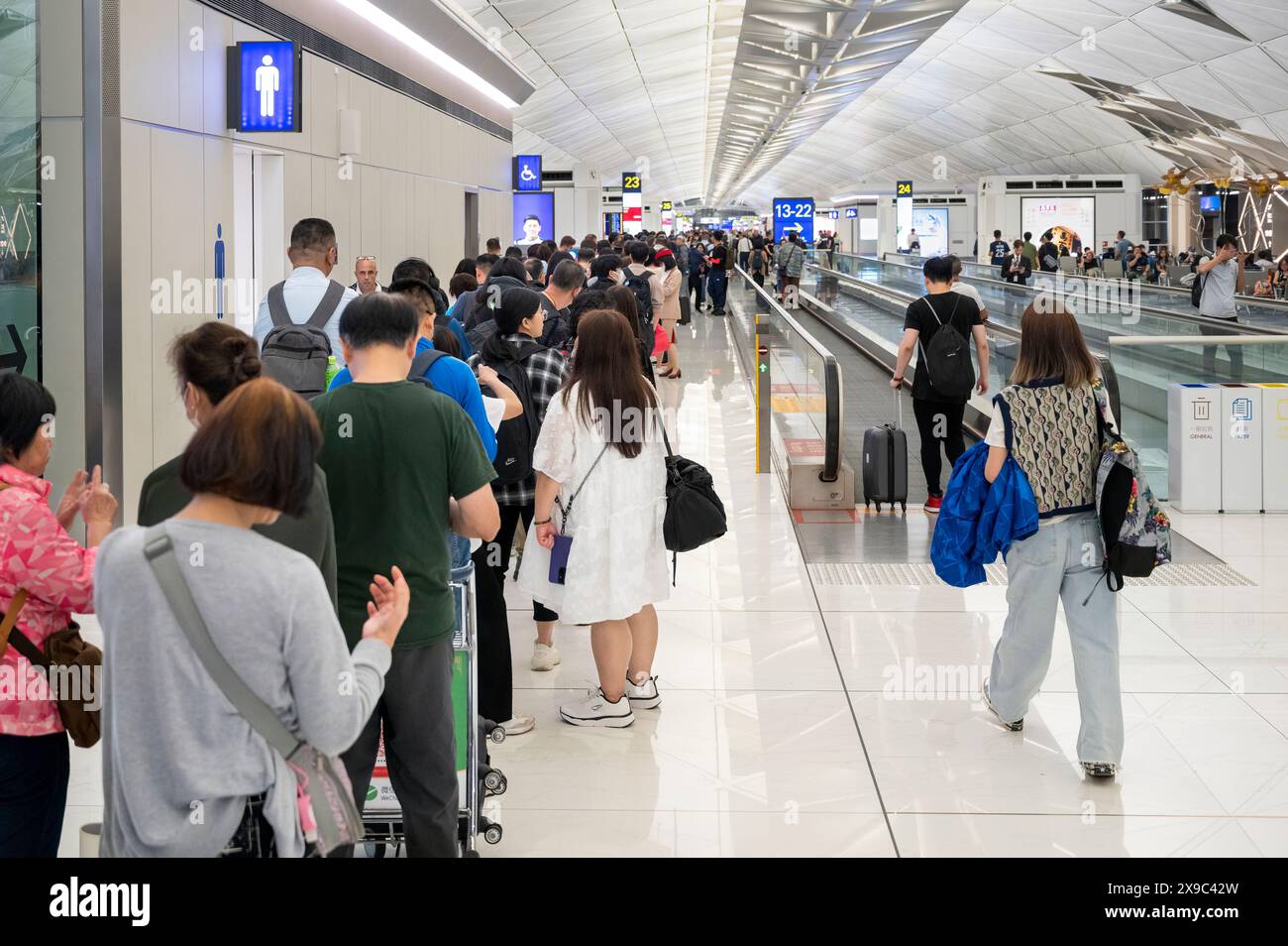Flight passengers queue in line at the boarding airline gate at Chek ...