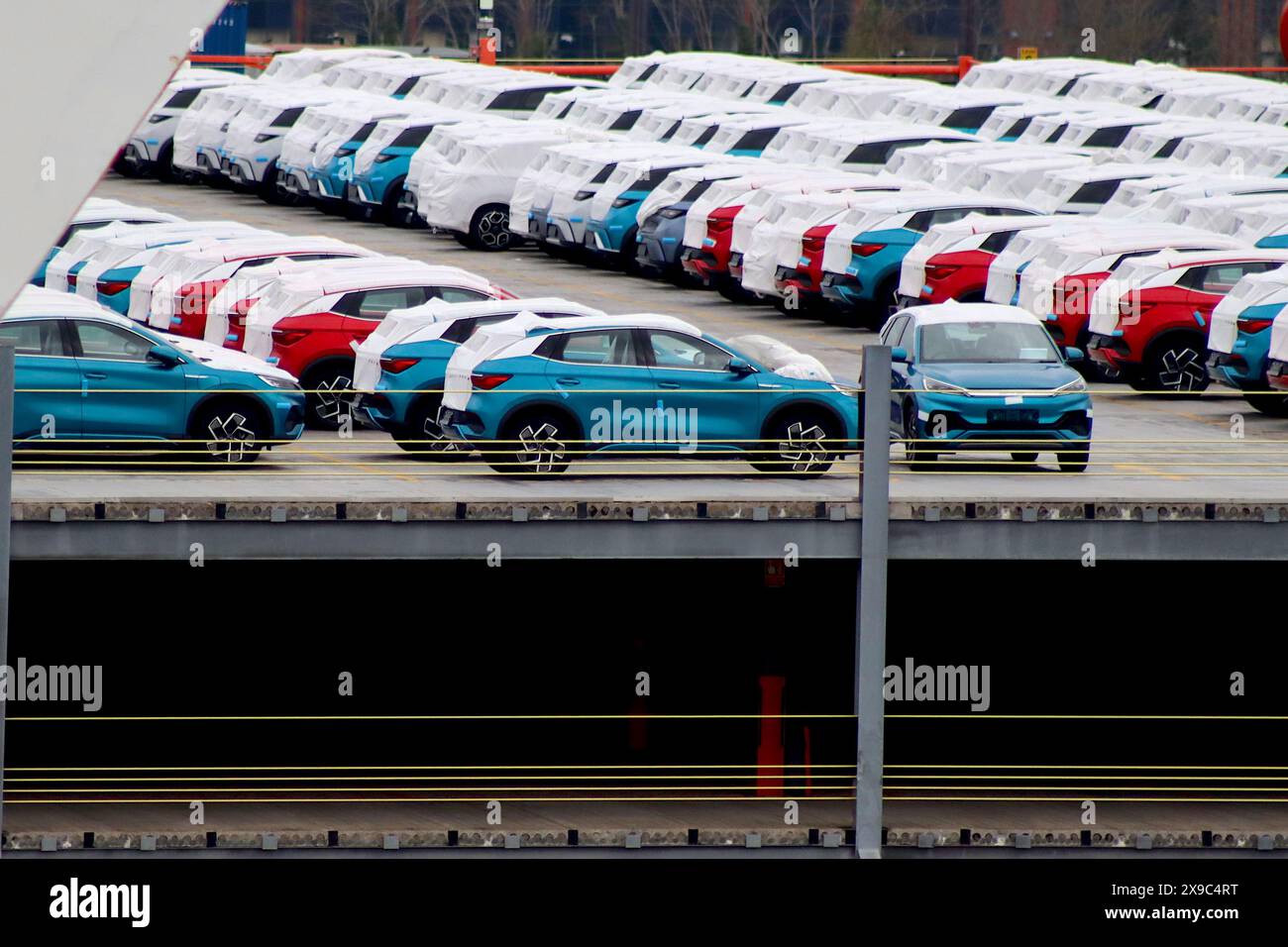 Rows of Chinese BYD Atto 3 electric SUVs parked in a vehicle holding ...