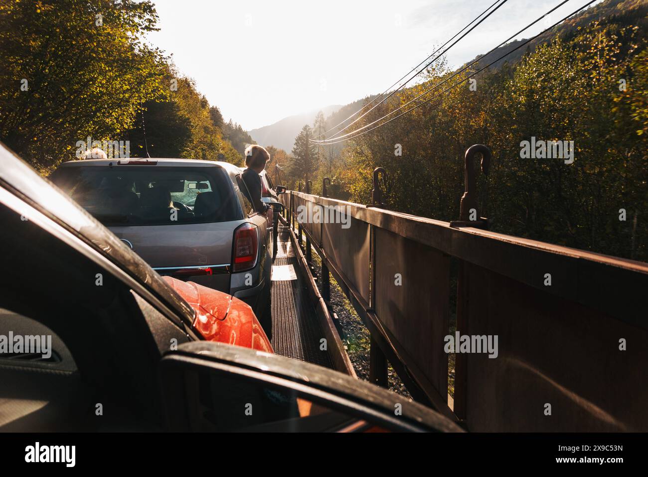 the view from inside a car traveling on mororail through the countryside in Slovenia. Two boys ...