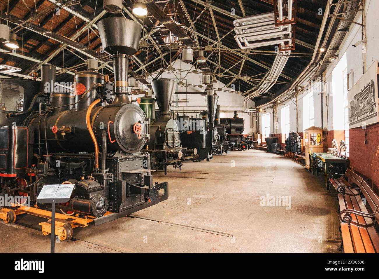 vintage steam locomotives on display in a shed at the Slovenian Railway ...