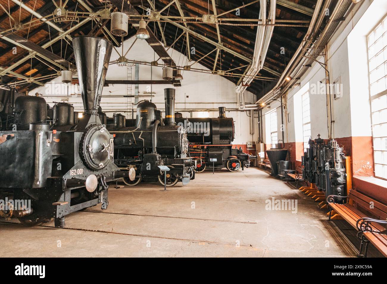 vintage steam locomotives on display in a shed at the Slovenian Railway ...