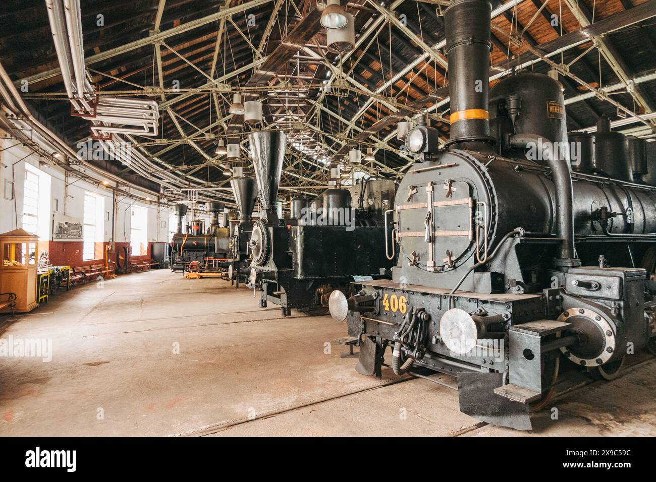 vintage steam locomotives on display in a shed at the Slovenian Railway ...