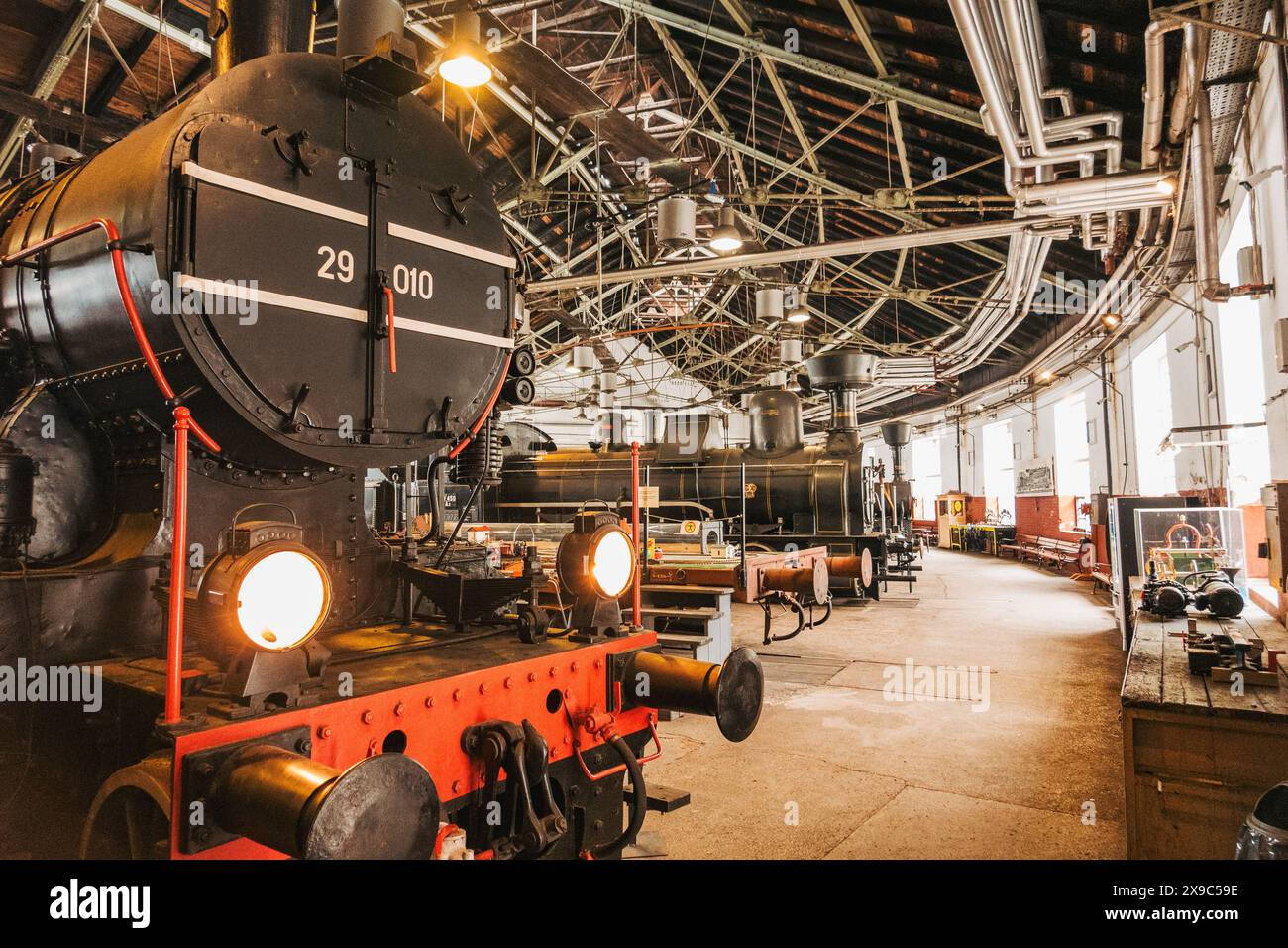 vintage steam locomotives on display in a shed at the Slovenian Railway ...
