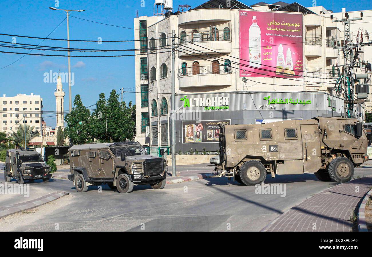 Jenin, Palestine. 30th May, 2024. Israeli military vehicles patrol in ...