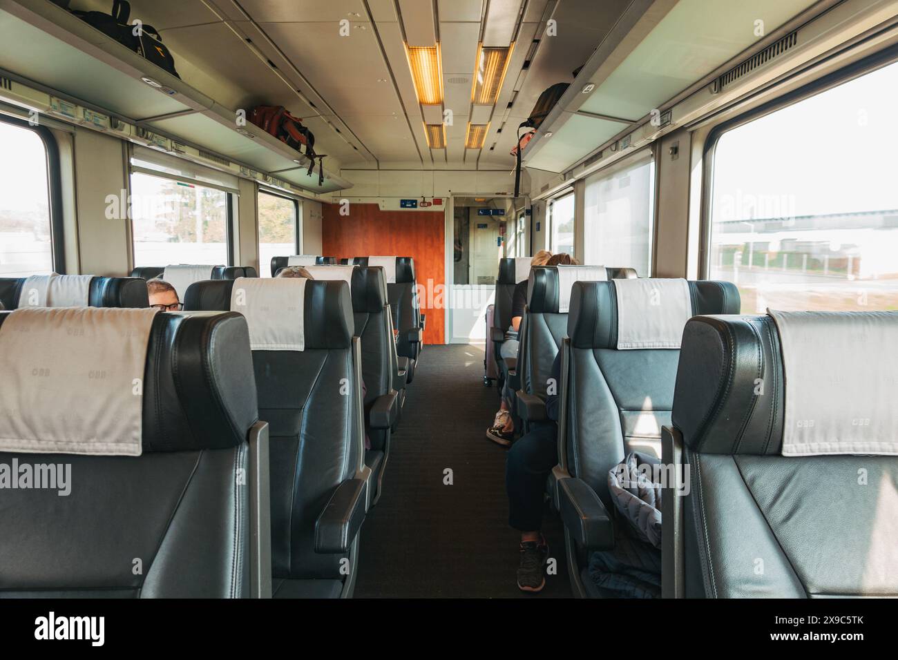 Inside an ÖBB Eurocity business class train car from Slovenia to Austria: faux leather seats ...
