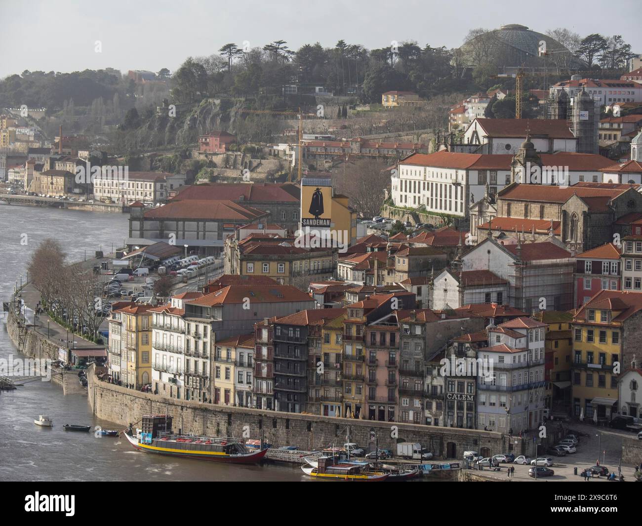 Image of a city with several buildings and hills, a river runs along ...