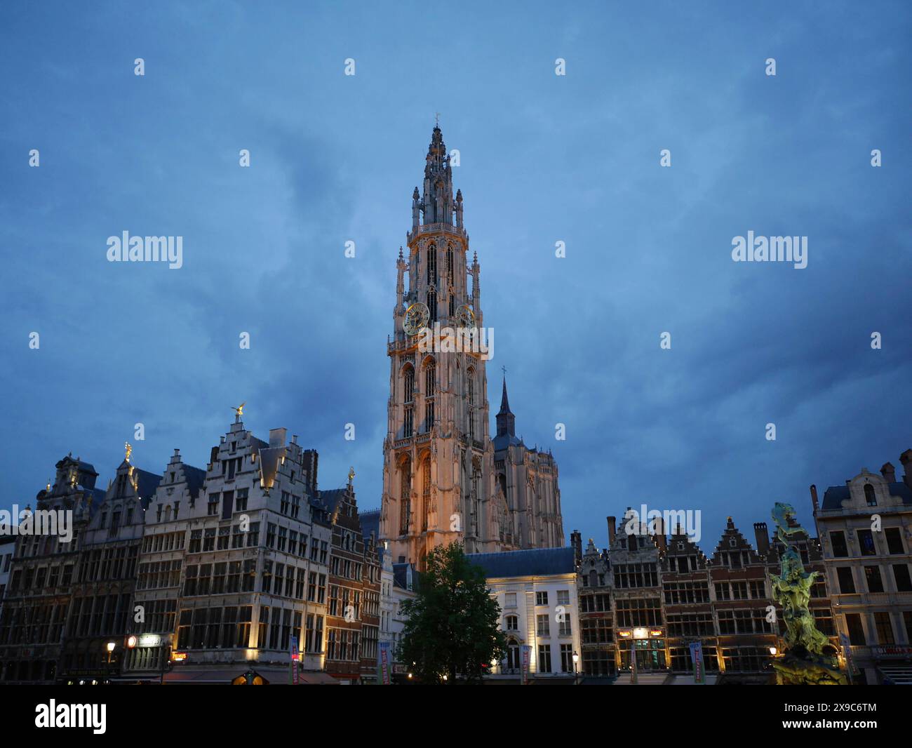 Church tower of a historic building at dusk with illumination, the ...