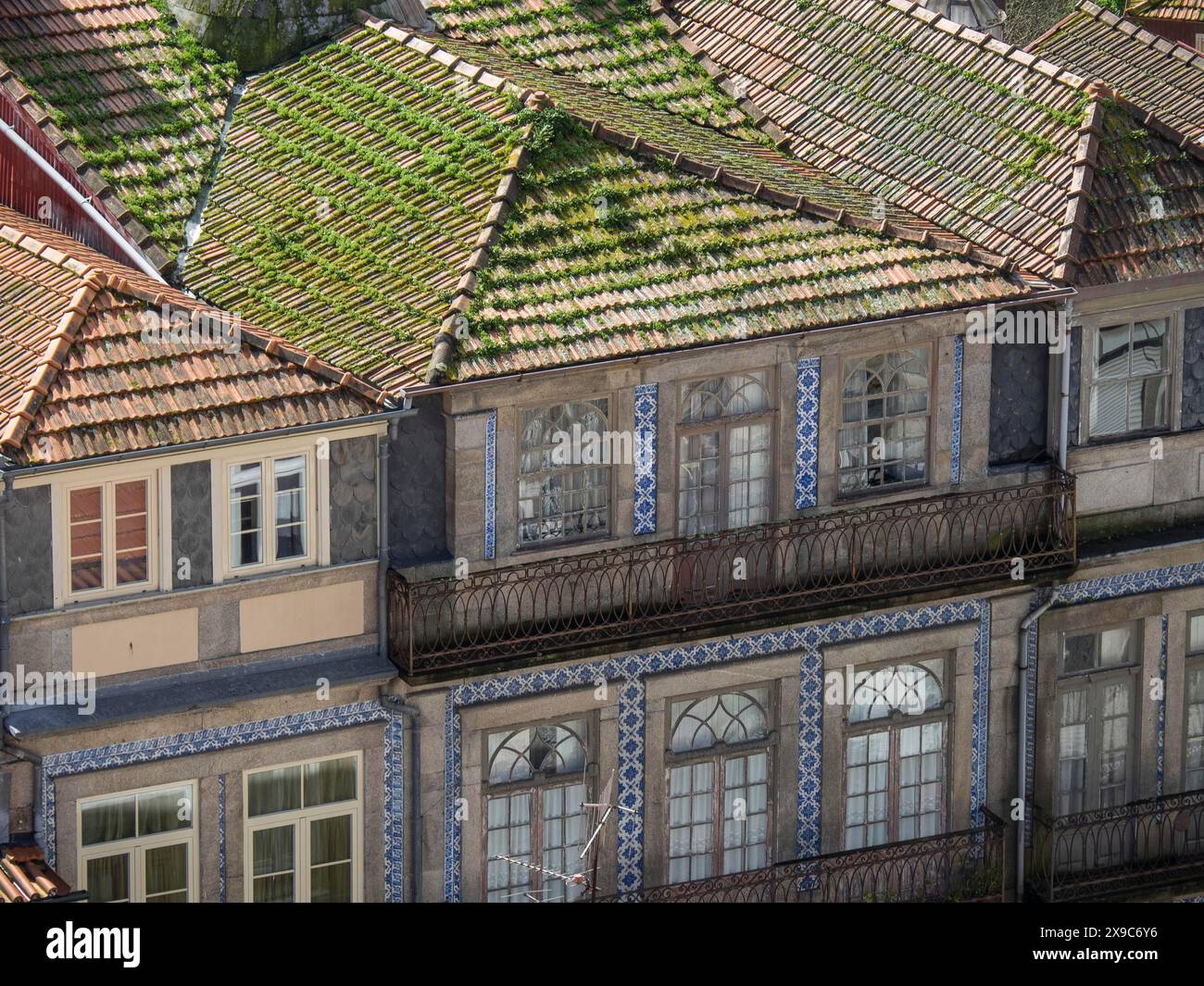 Historic buildings with green tiled roofs and decorative tiles create a ...