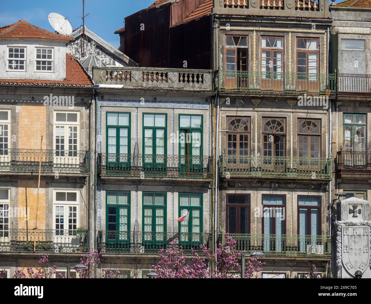 Old town houses with colourful shutters and balconies in an urban scene ...