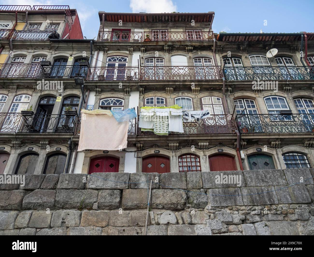Close-up of historic buildings with ornate balconies with laundry ...