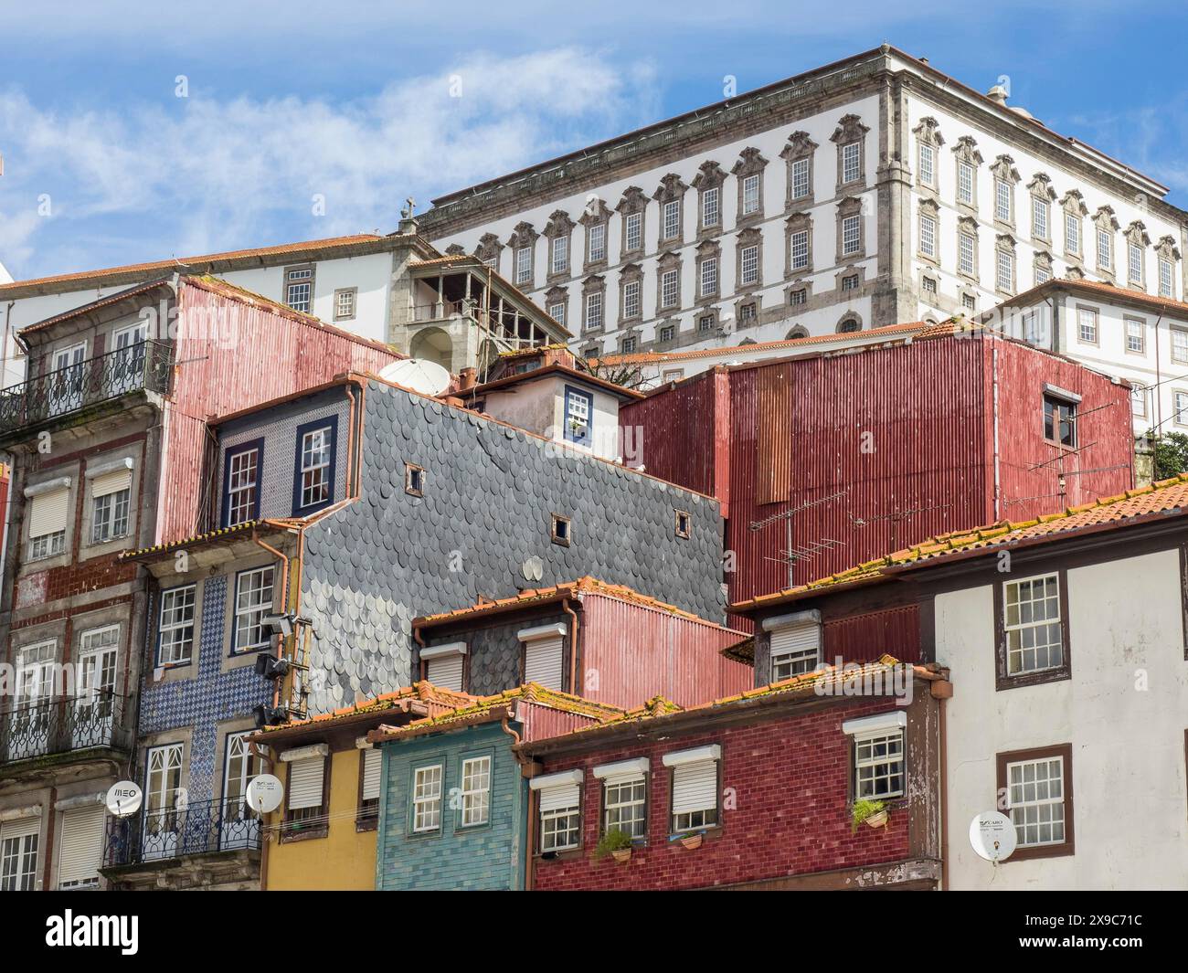 Multi-storey, colourful buildings with tiled roofs in an old town with ...