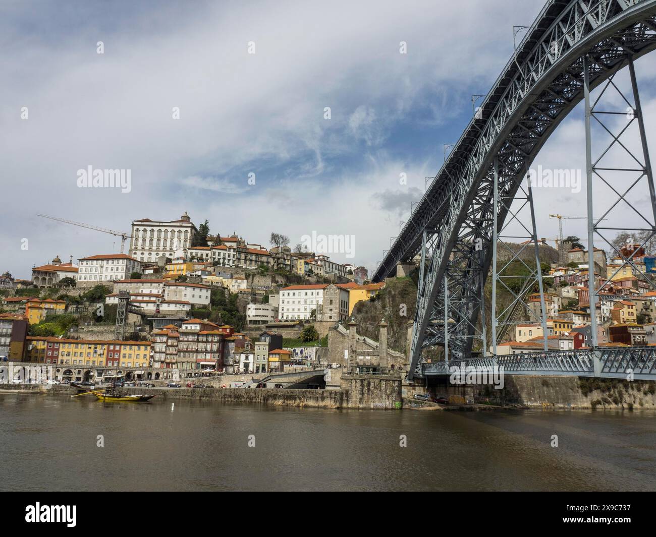 Large arched bridge over a river connecting a city with a variety of ...