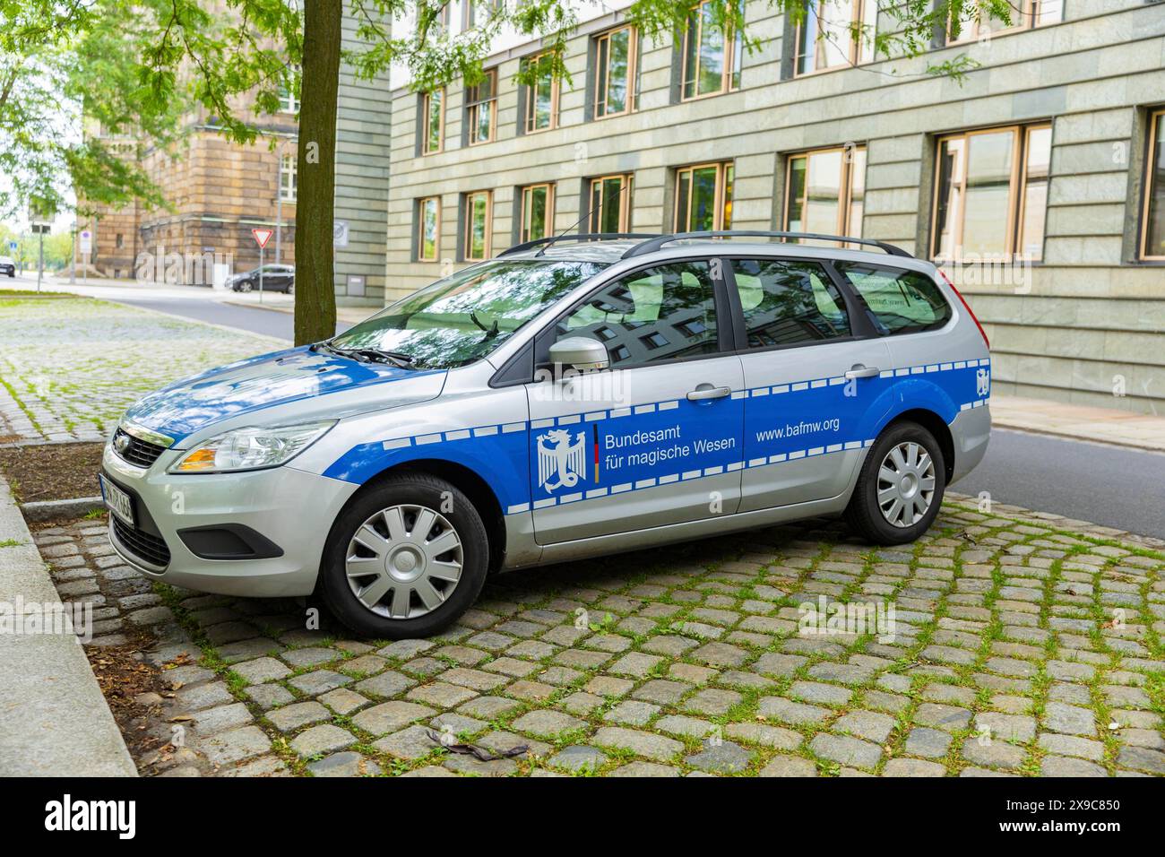 A car similar to a police car advertising a bookshop is parked in the ...