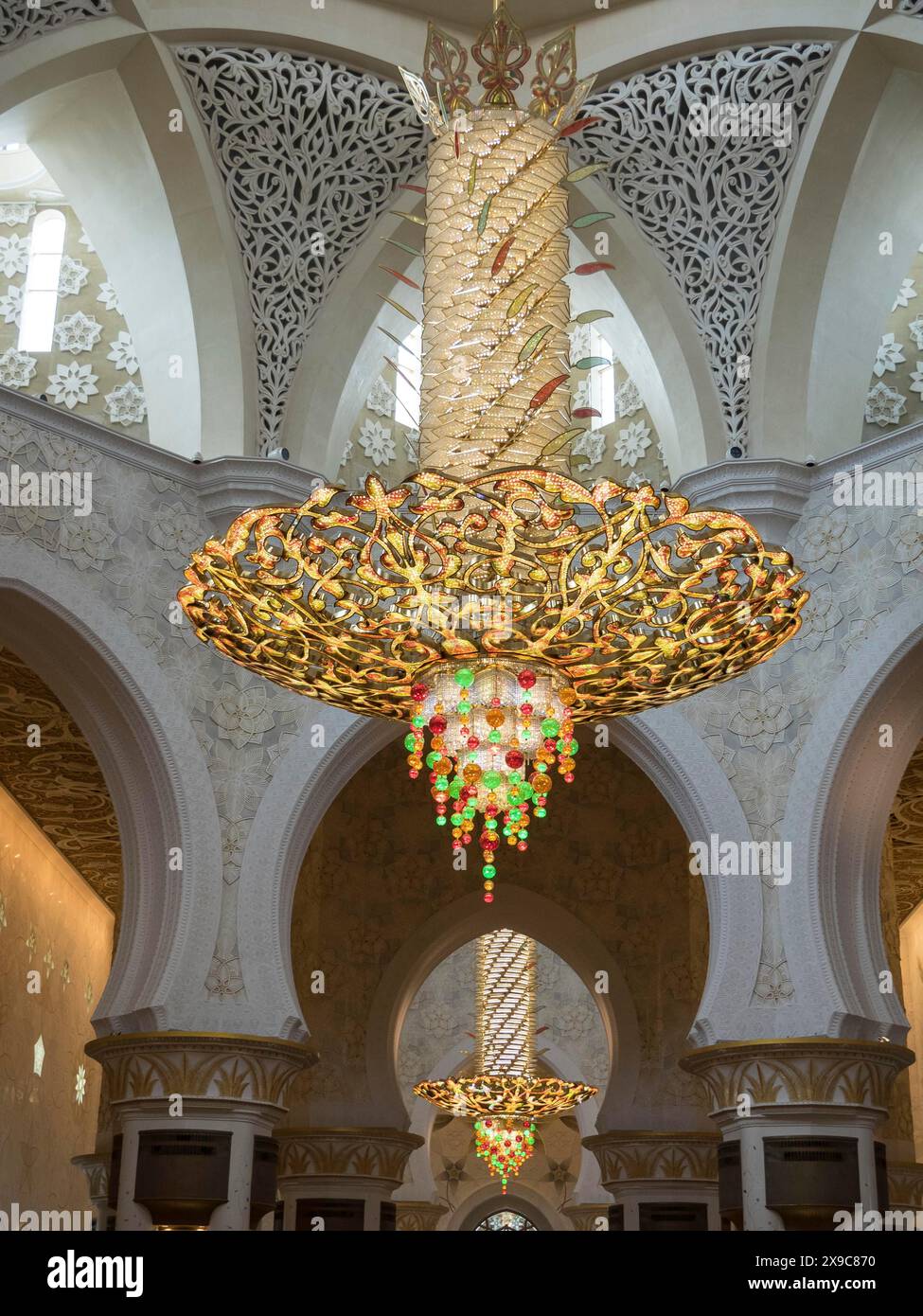 An ornate interior with large arches and a magnificent chandelier that ...