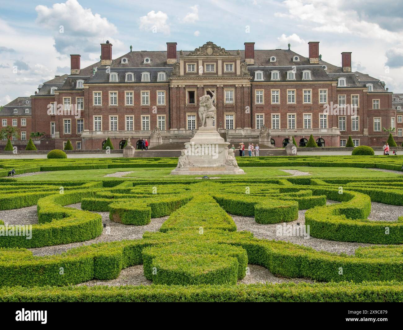 Historic castle with stone sculpture and well-kept hedge garden, old ...