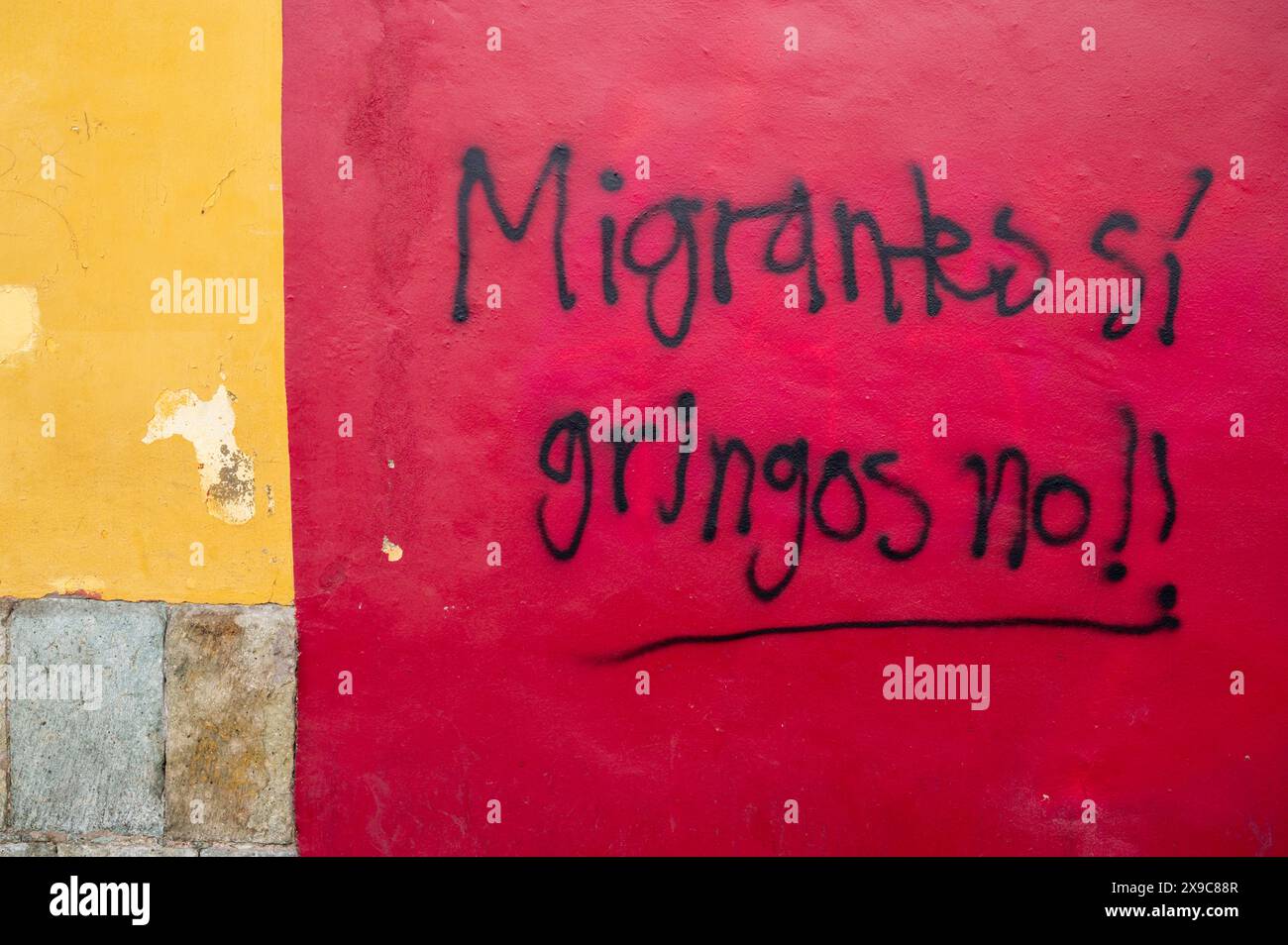 Anti foreigner pro migrant grafitti on wall in Oaxaca City Mexico Stock ...