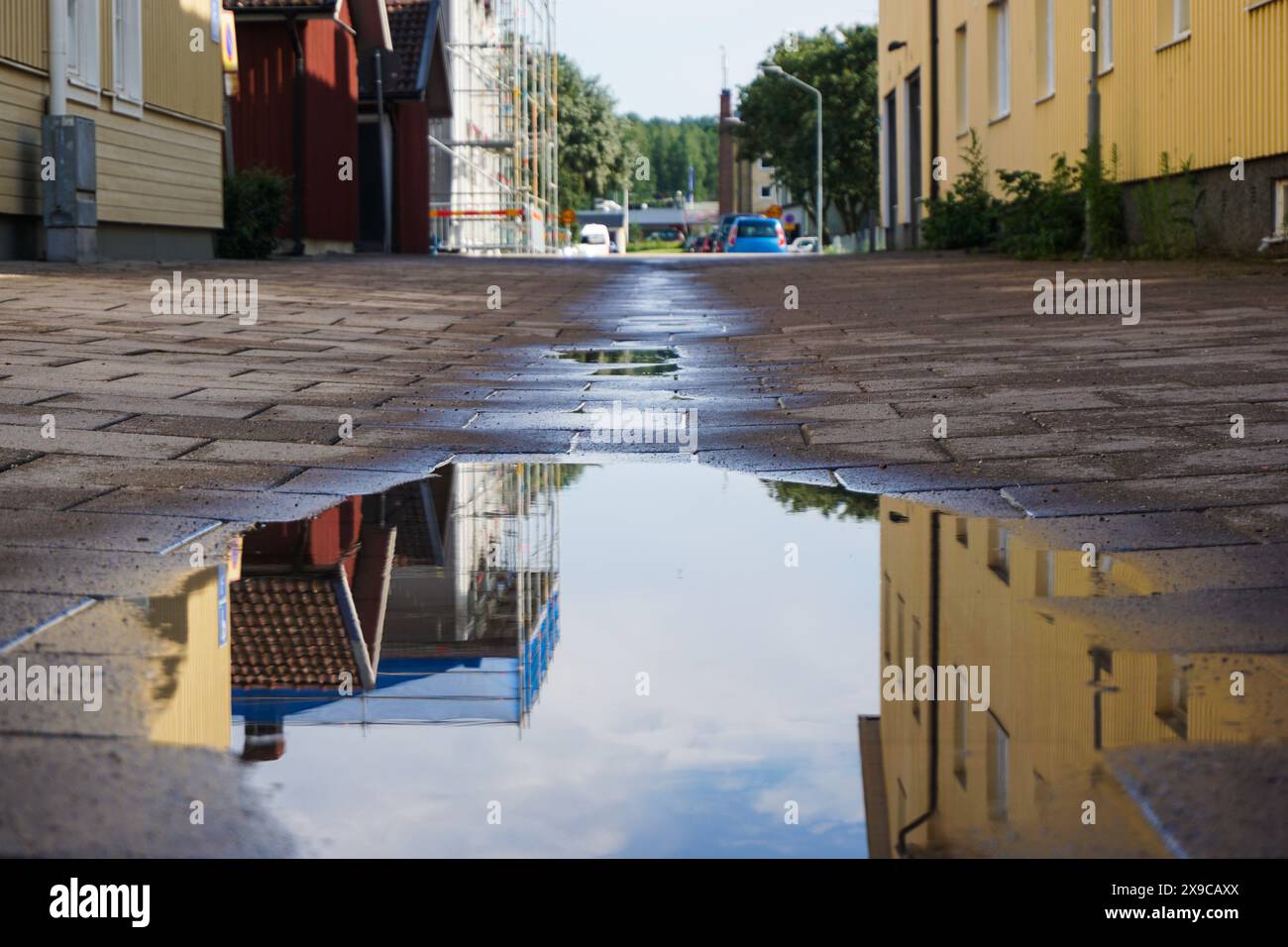 Puddle on alley street hi-res stock photography and images - Alamy