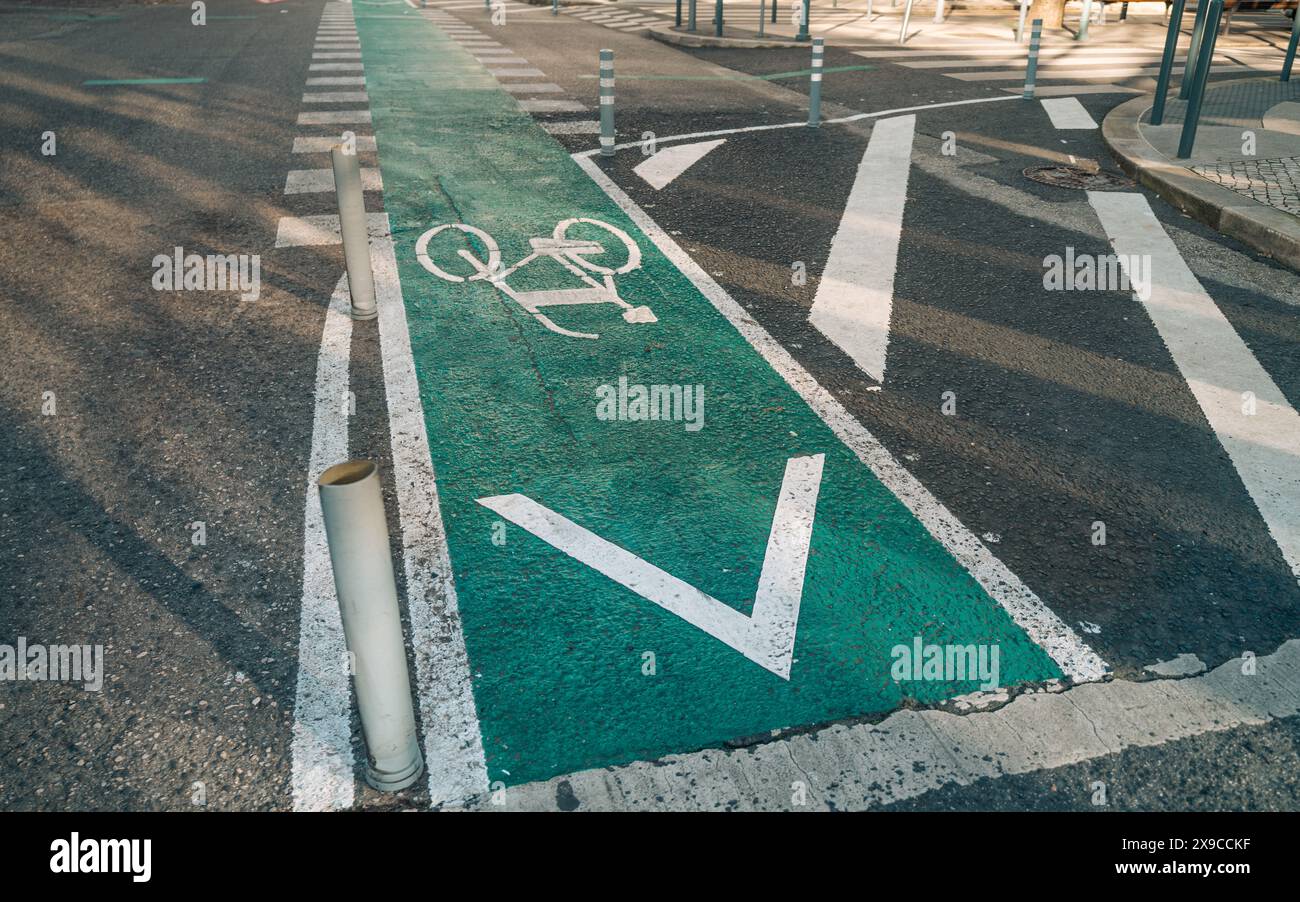 A dedicated green bike lane marked with white bike symbol and ...