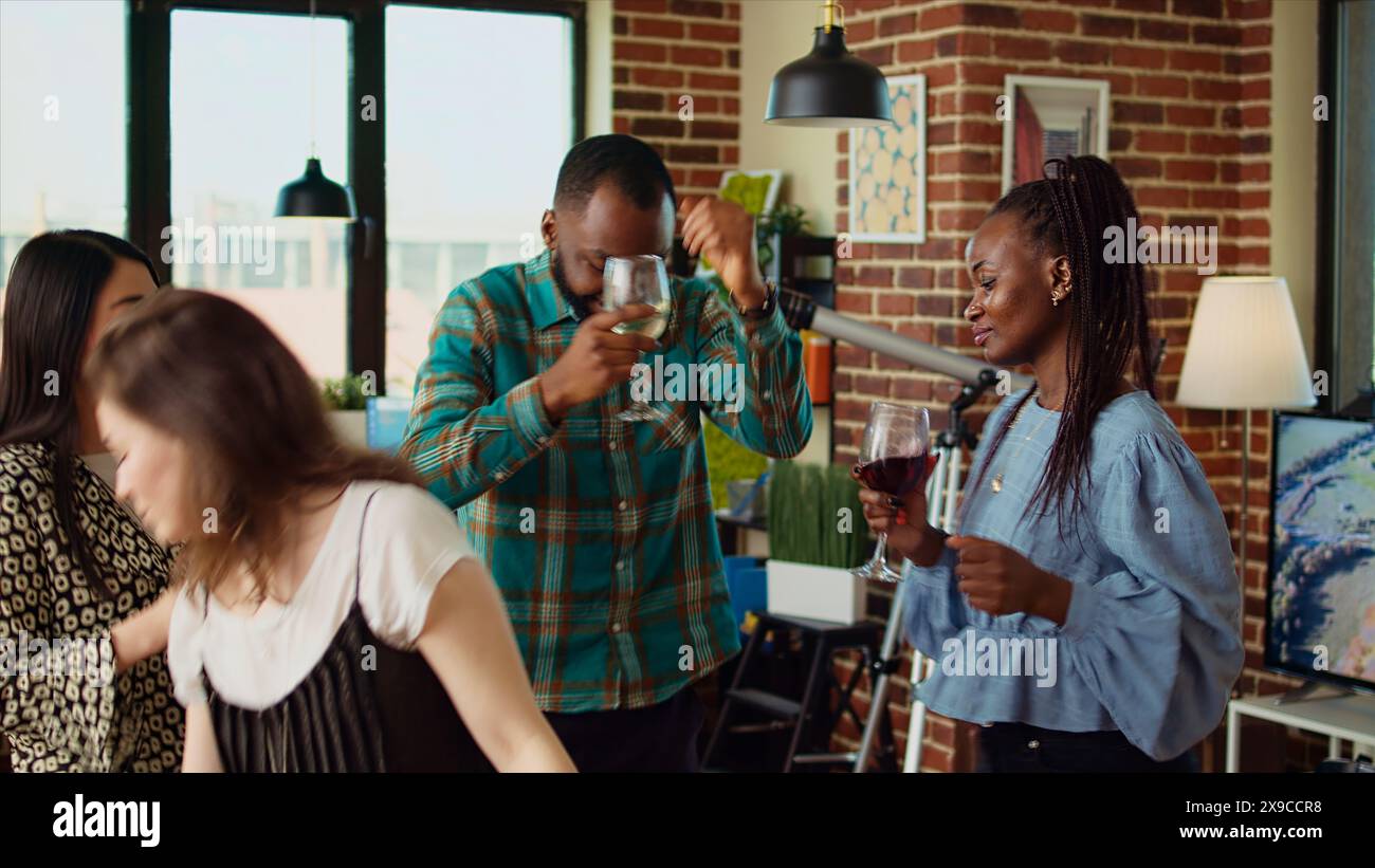 Multiracial school colleagues organizing apartment party ...