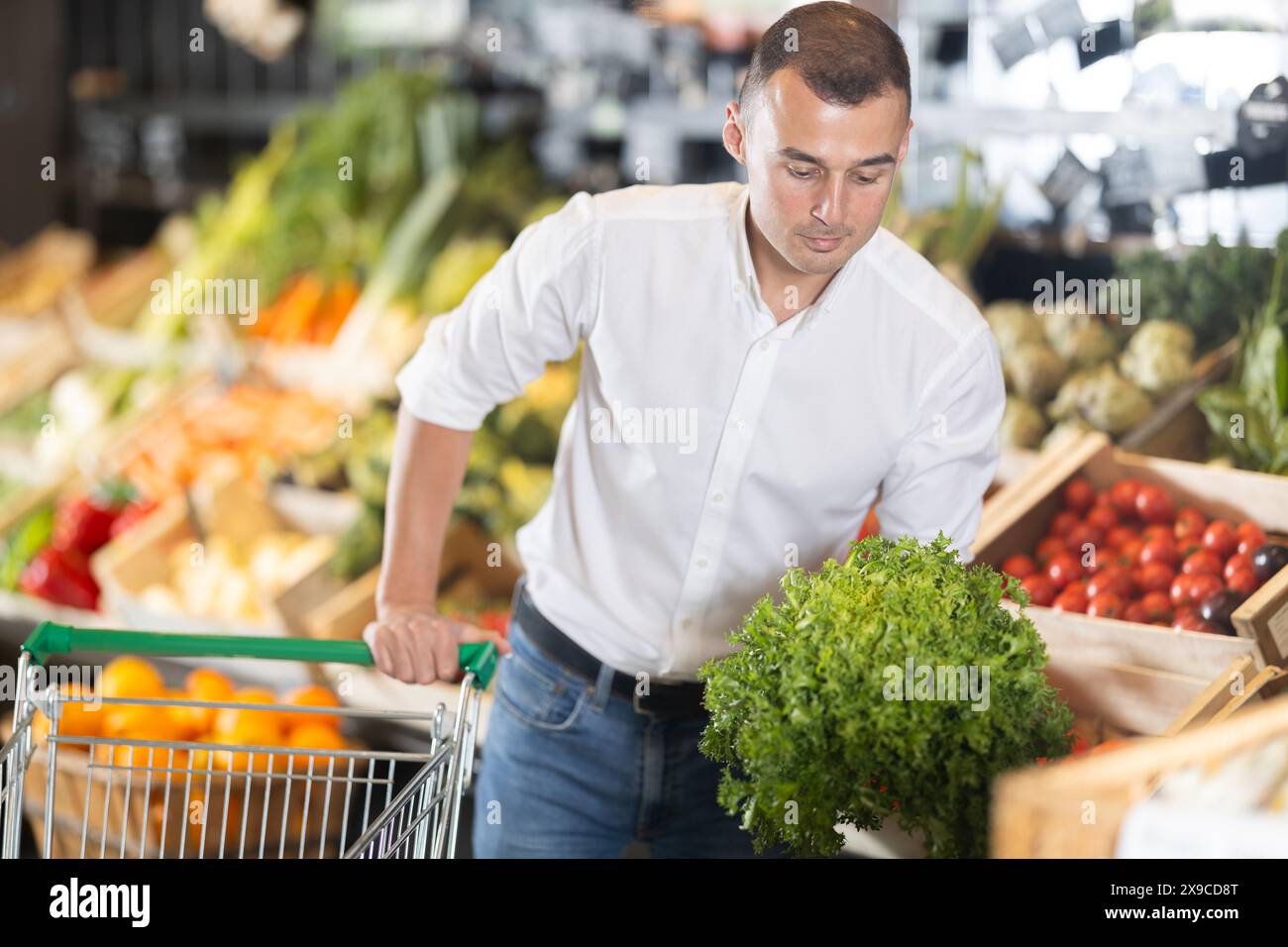 In vegetable department of bio supermarket, male customer took crisp ...