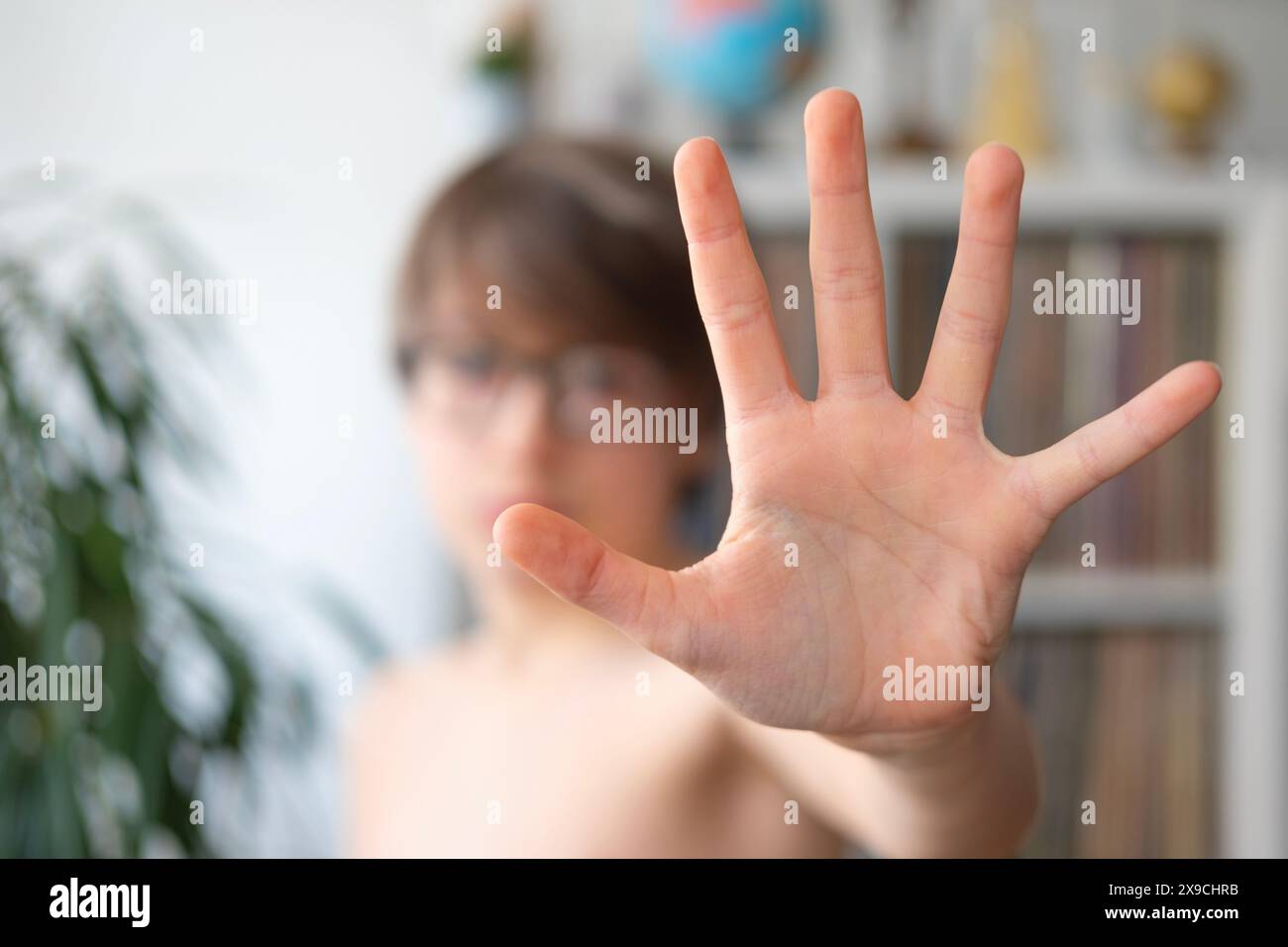 Child, 11-year-old boy extending hand to signal stop, stopping gesture ...