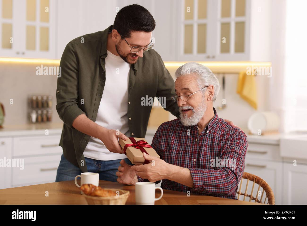 Happy grandfather giving gift box hi-res stock photography and images ...