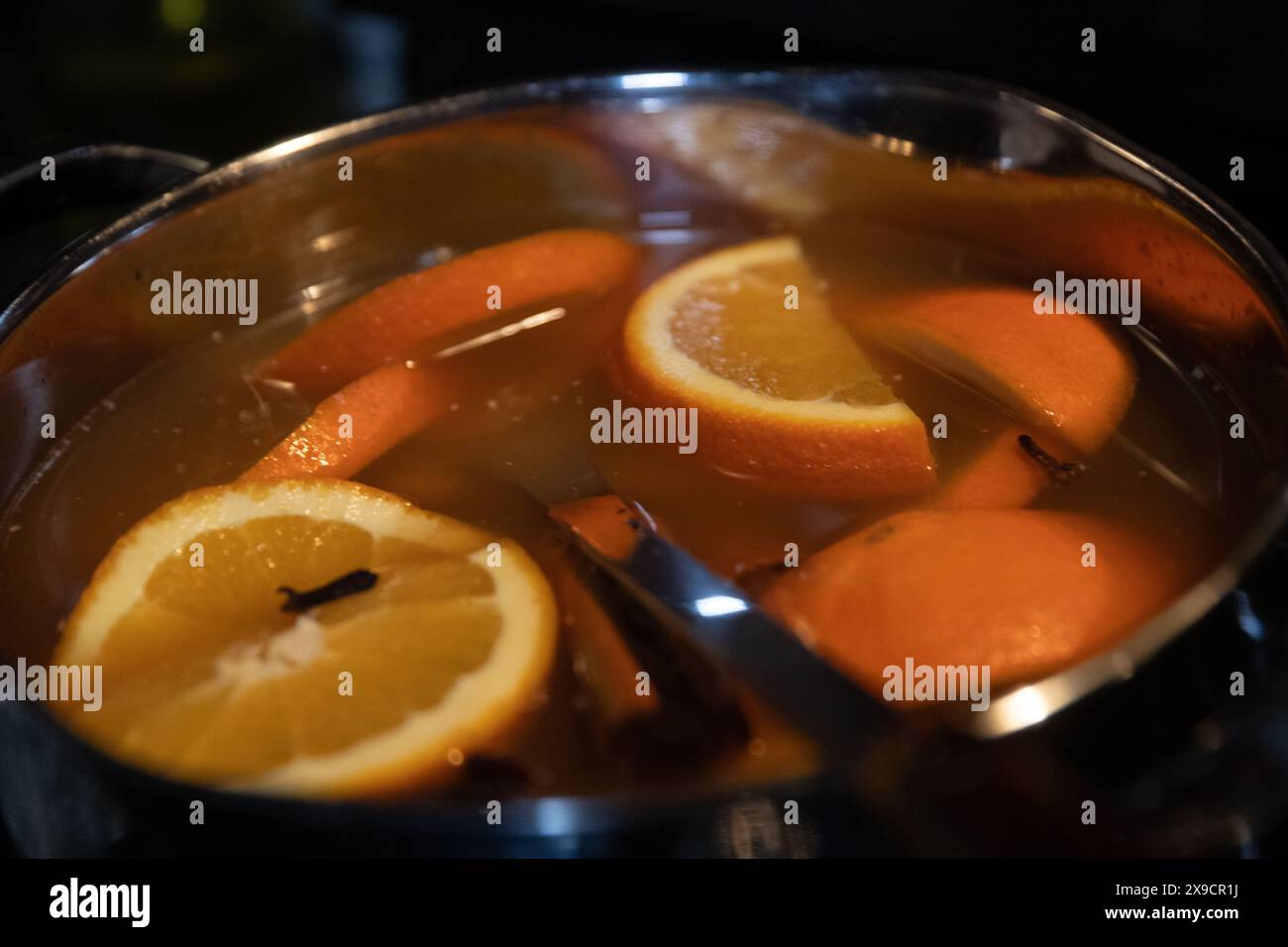 Spiced Apple Cider simmering on the stove Stock Photo - Alamy