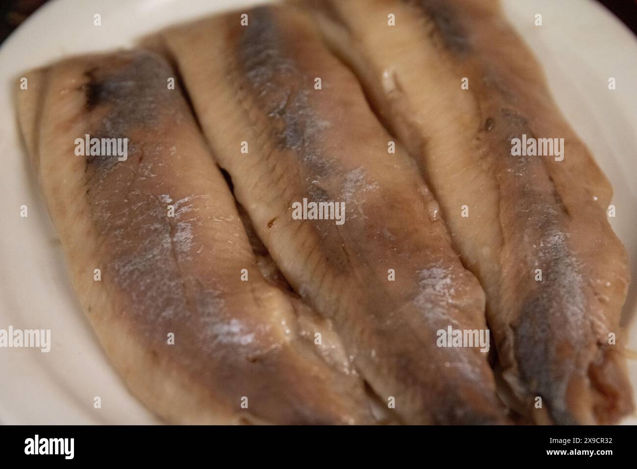 Three Haring Filets cleaned ready to eat Stock Photo - Alamy