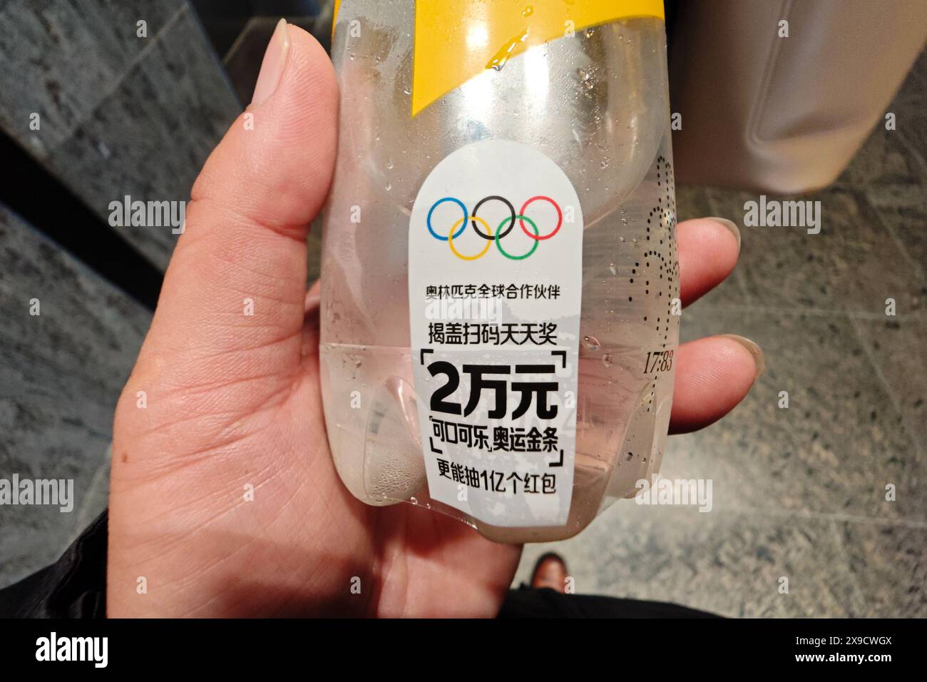SHANGHAI, CHINA - MAY 31, 2024 - A citizen holds Coca-Cola's Olympic ...