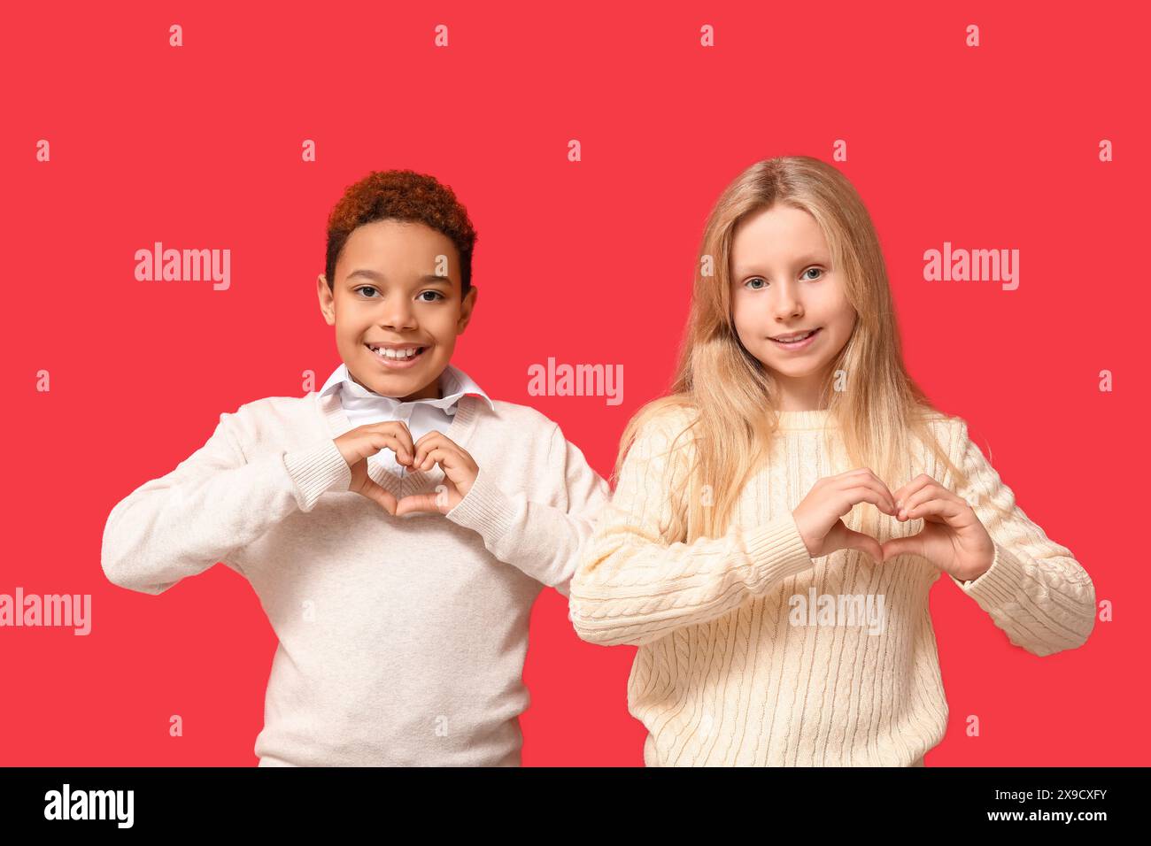 Cute little children showing heart gesture on red background. Valentine ...