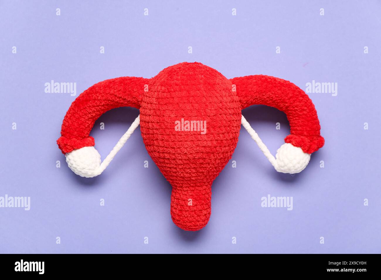 Knitted uterus on purple background Stock Photo - Alamy