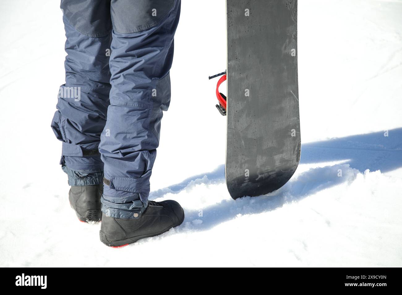 Legs of snowboarder on ski resort, back view Stock Photo - Alamy