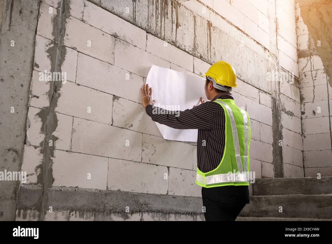 young professional engineer worker in protective helmet working at ...
