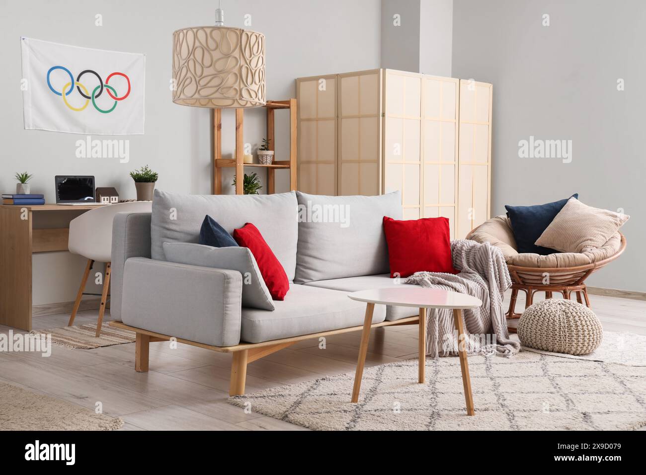 Interior of living room with grey sofa, armchair, coffee table and ...