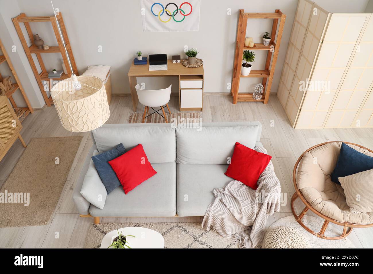 Interior of living room with grey sofa, armchair, coffee table and ...