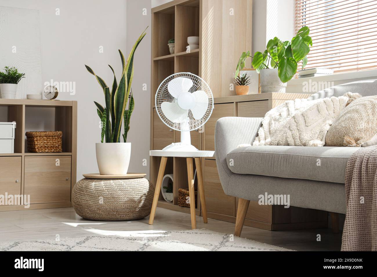 Electric fan on table in living room interior Stock Photo - Alamy