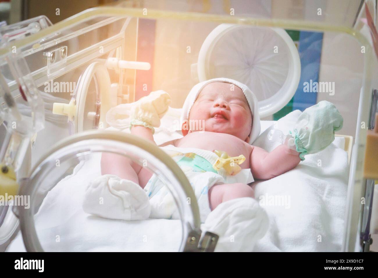 Newborn baby girl inside incubator in hospital post delivery room Stock ...