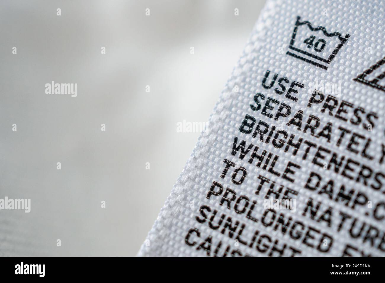 Cloth label tag with laundry care instructions Stock Photo - Alamy