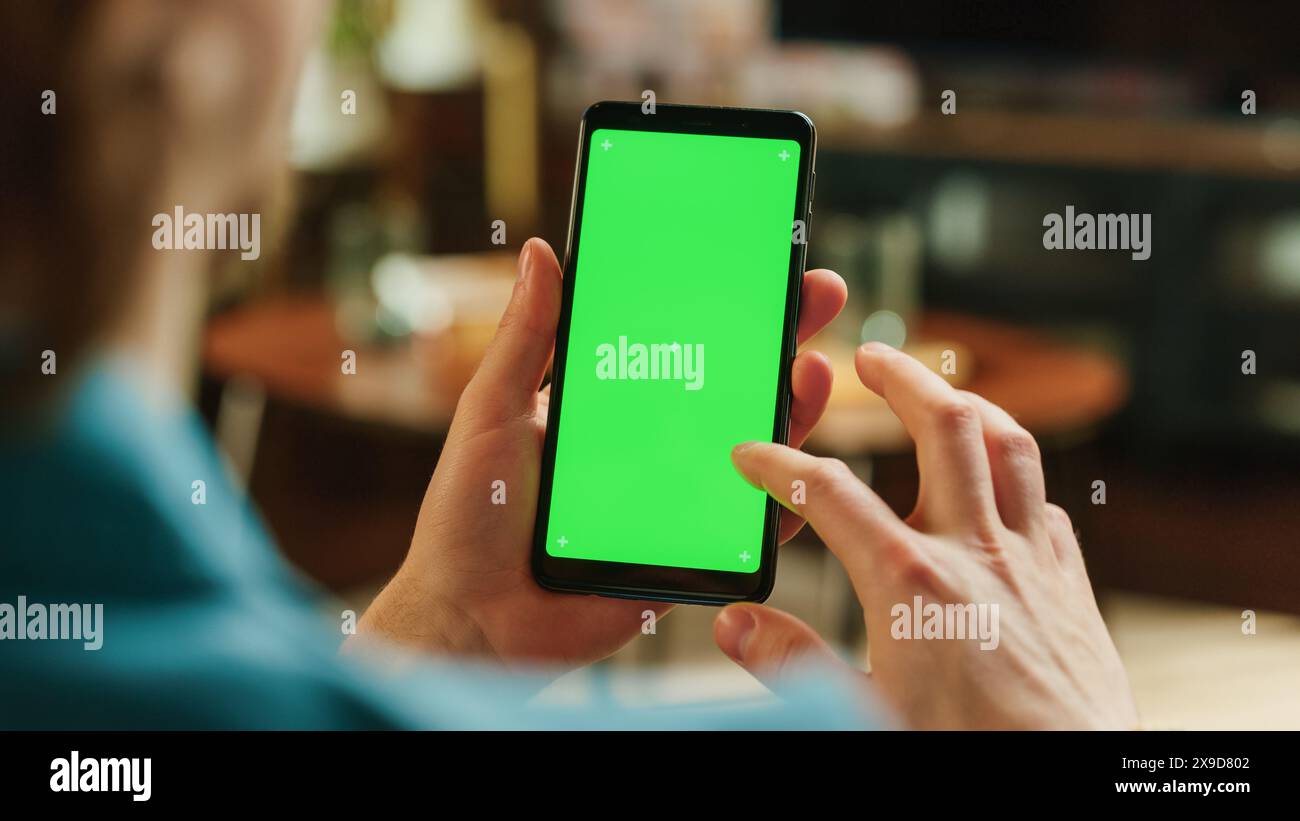 Man Scrolling Feed and Double Tapping on Display on Smartphone with Green Screen Mock Up Display ...